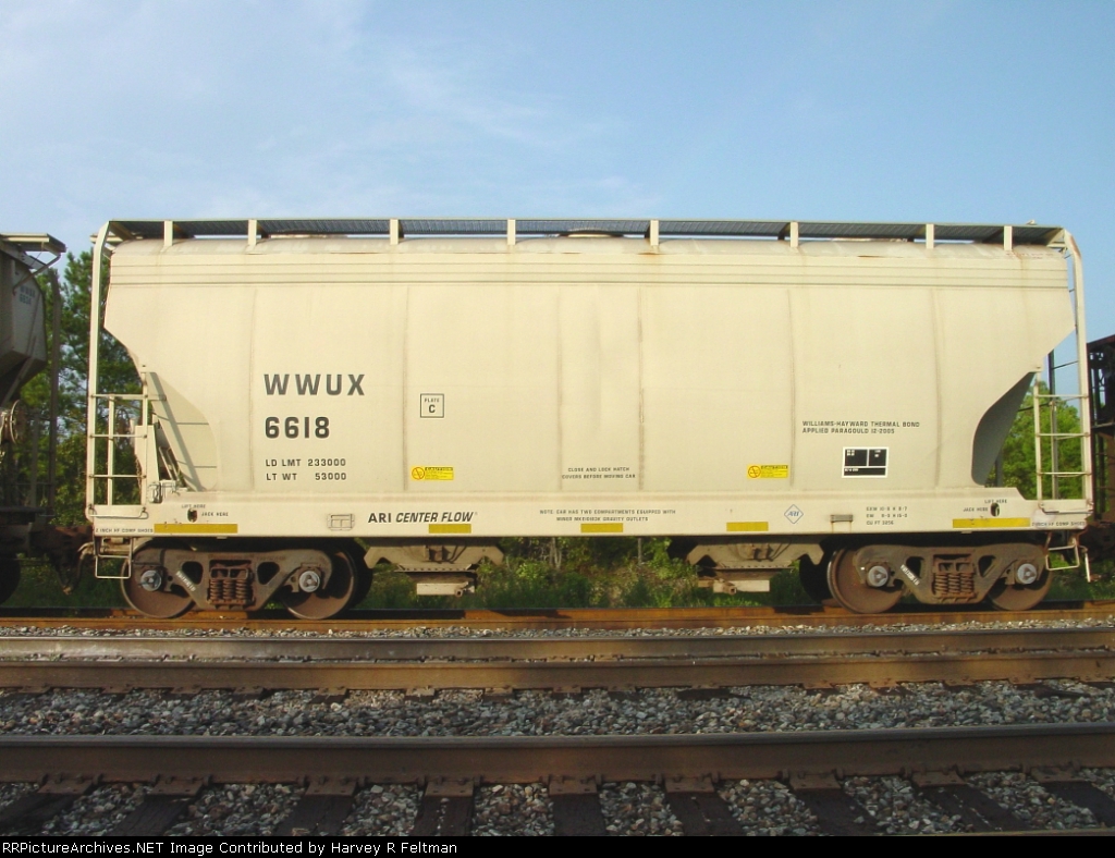 WWUX 6618, a 40 foot twin bay covered hopper, assigned to Unimin Sand Company's silica sand ...